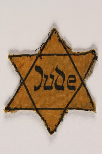 Star of David yellow cloth badge printed with Jude, the German word for ...