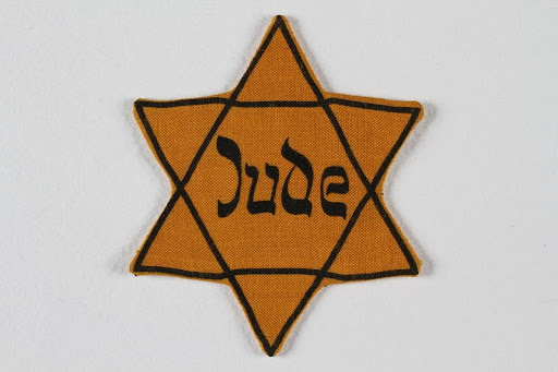 Yellow Star of David badge with Jude worn by a young German Jewish boy ...