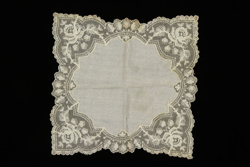 White silk handkerchief with handmade floral lace design brought to the ...